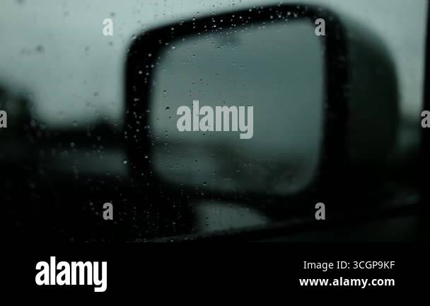 Raindrops on a car window, macro, blurred background, cloudy and dark ...