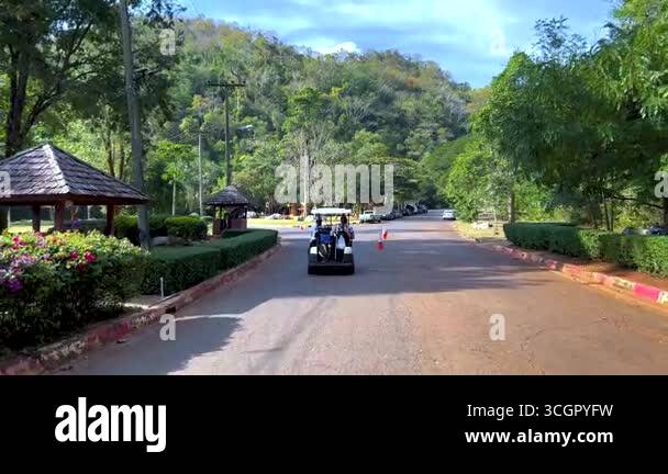 Golf cart driving through lush, scenic course Stock Video Footage - Alamy