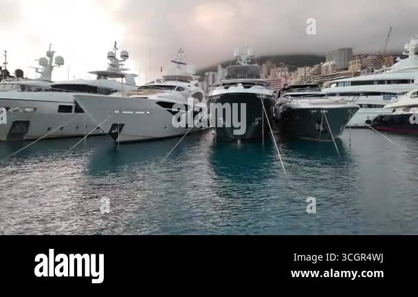 La Condamine, Monaco - July 4, 2025: Row of sleek luxury yachts, docked in Port Hercules with ...