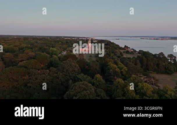 aerial wide angle drone shot flying straight towards old English chapel ...