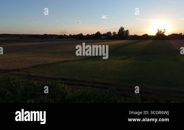 Aerial panoramic view of golden fields at sunset, with warm sunlight ...
