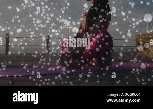 Fitness instructor practicing mindful breathing on pink mat facing calm ...