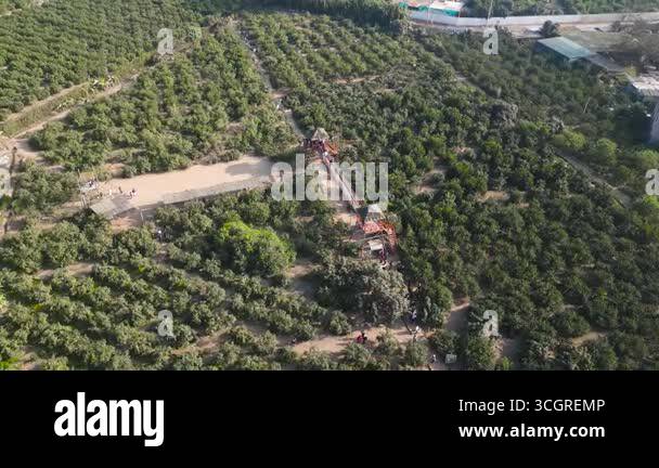 Aerial drone footage of tourists on a wooden zipline platform above ...