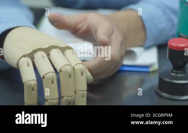 Close up hands of disabled employee with prosthetic arm. High quality ...