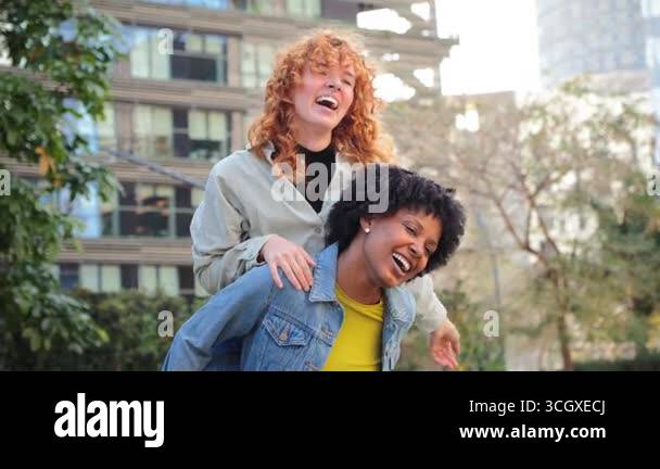 Two cheerful girls are having fun together in a playful manner while ...