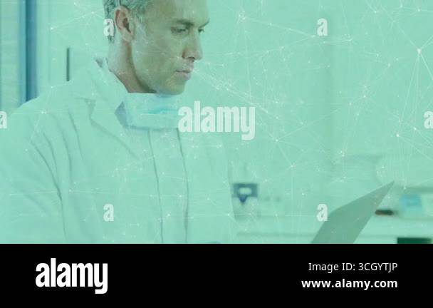 Lab technician tapping tablet screen reviewing medical data while ...