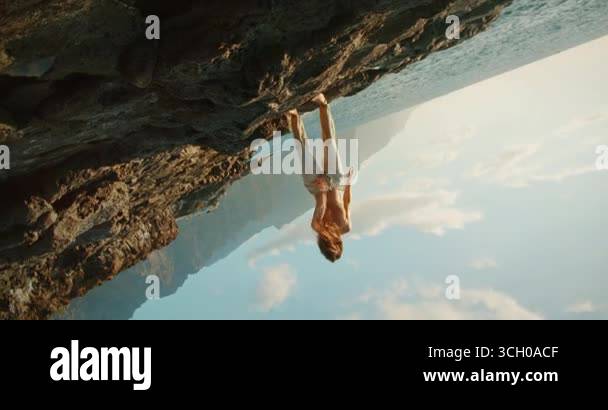 Contemporary dancer moving on coastal cliffs with ocean view at ...