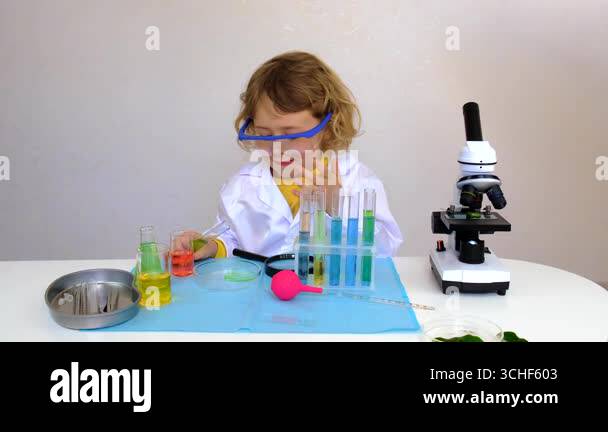 Laboratory examination of a child with test tubes, reagents and a ...