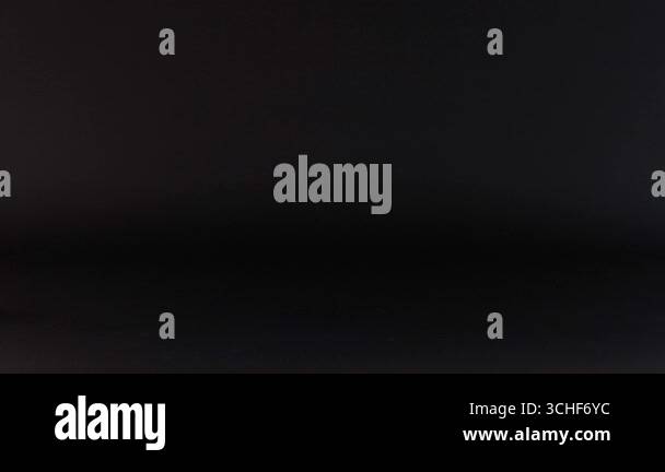 A pink ball rolls across a dark surface Stock Video Footage - Alamy