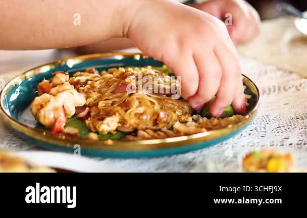 Squeezing lime over delicious Pad Thai dish Stock Video Footage - Alamy