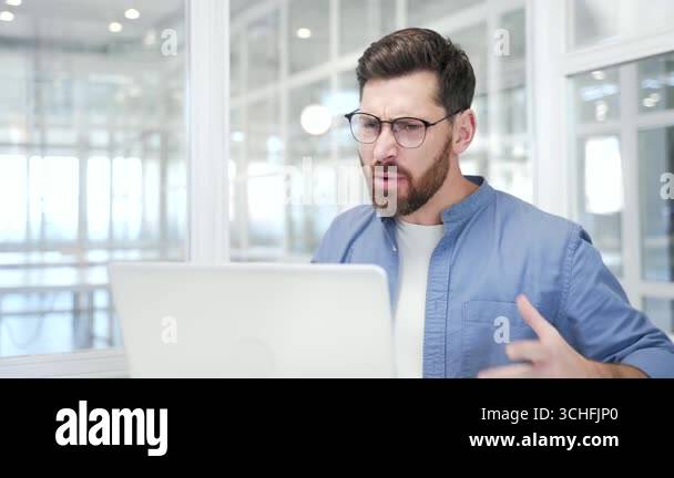 Angry businessman arguing talking on video call using laptop computer ...