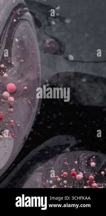 Vertical video. Oil pigment drop. Bubble emulsion. Red white paint ...