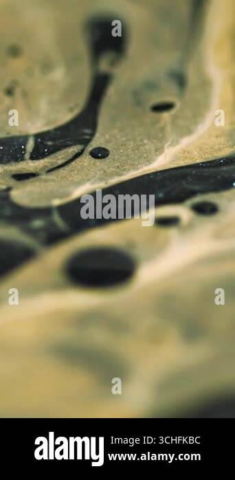Vertical video. Serum blob. Blur fizzy liquid. Defocused yellow black ...