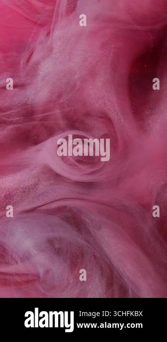 Vertical video. Glitter smoke. Ink water swirl. Defocused pink color ...