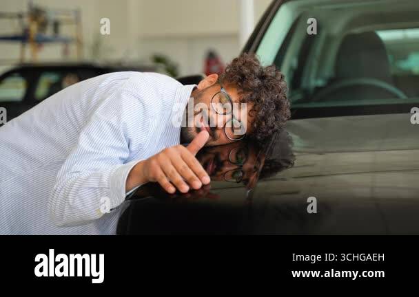 Proud car owner gently caressing newly purchased vehicle, radiating ...