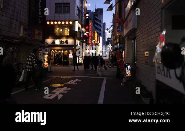 Pedestrians walking on a lively urban street at dusk Stock Video ...
