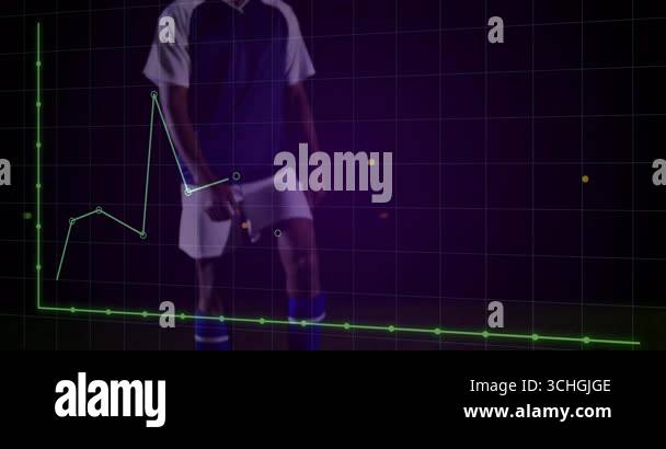 Male soccer player shifting weight and kicking ball on grid pitch while ...