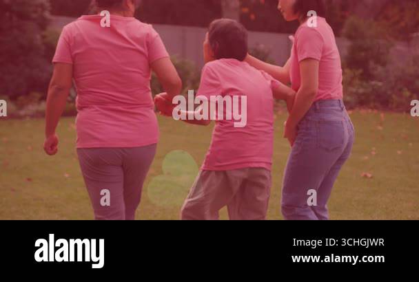 Family trio linking arms walking across yard, initiating floating heart ...