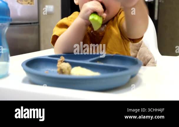 Baby Feet on High Chair with Food Crumbs close up Stock Video Footage ...