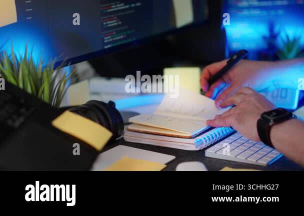 wireframe in notebook near computer monitor with code, modern office ...