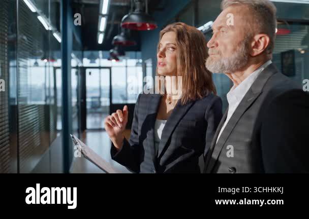 Wealthy business people talking in modern office center hall closeup ...