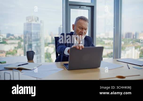 Tired entrepreneur closing laptop holding head feeling exhausted in ...