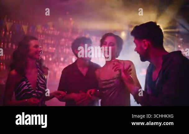 Cheerful group clubbing in night club having fun together closeup ...