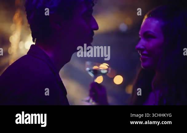 Two clubbers dancing together at modern dark nightclub closeup. Relaxed ...