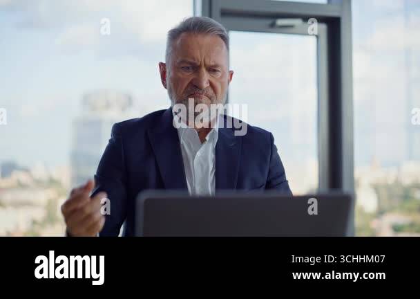 Furious investor gesturing to laptop webcam complaining on bad ...