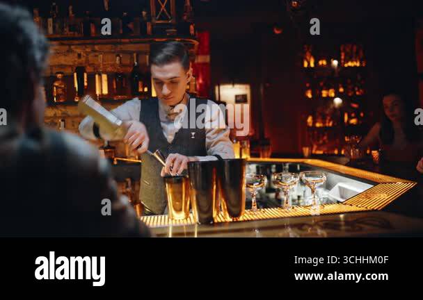 Elegant bartender making cocktail in modern nightclub closeup ...
