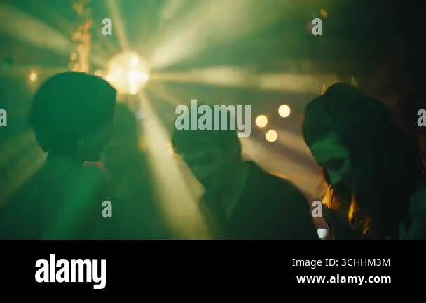 Relaxed crowd dancing in nightclub enjoying carefree weekend hangout ...
