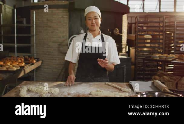 Animation of happy asian female baker cleaning hands from four and ...