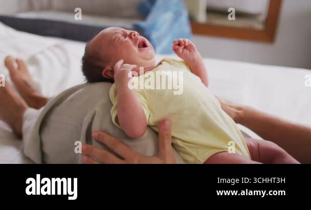 Video of newborn baby holding by mum and crying. motherhood, parental ...