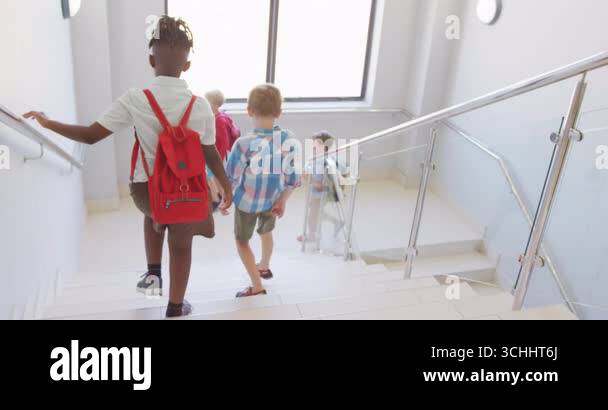Video of diverse boys walking on stairs at school. primary school ...