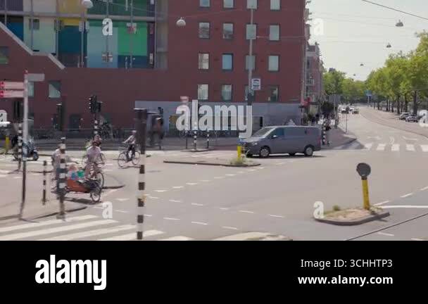 Amsterdam, Netherlands July 29 2025: Red brick corner building with ...