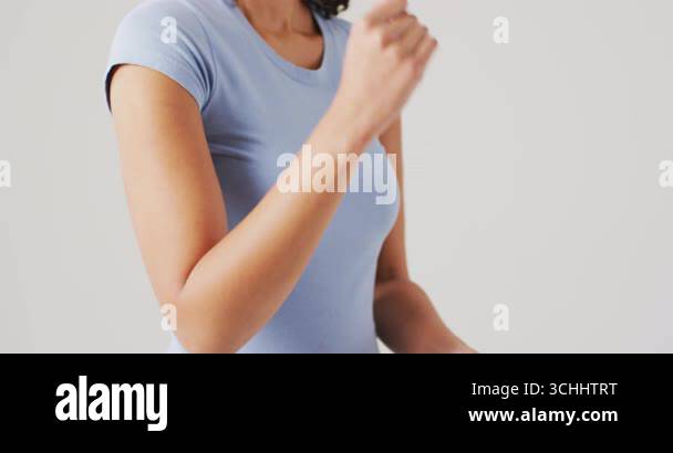 Video of woman touching her elbow on white background. global medicine ...