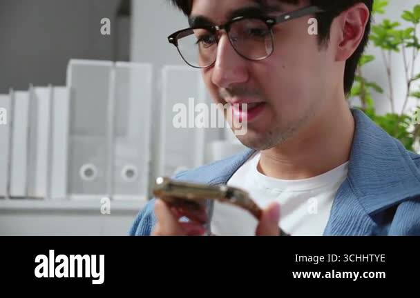 Caucasian man talk to AI assistant on smartphone in home office, remote ...