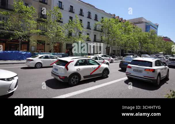 BARCELONA, SPAIN - JULY 5, 2025: Busy urban street scene captures the ...