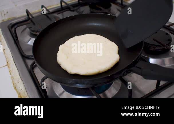 ooking Arepa on Frying Pan, Grilling Corn Arepa on Stove, Traditional ...