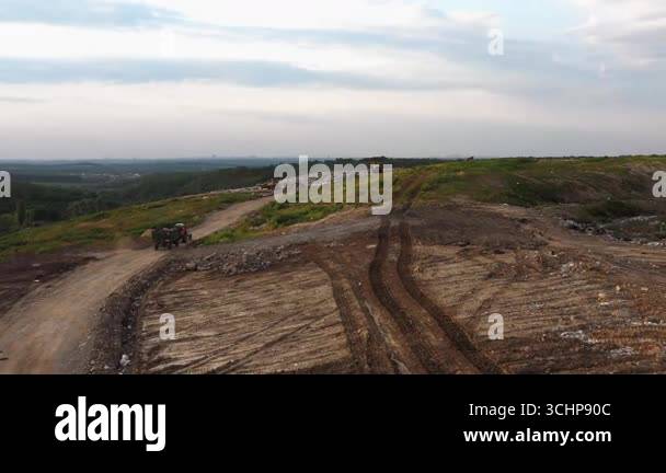 Transport on the countryside garbage field trail. Aerial perspective ...