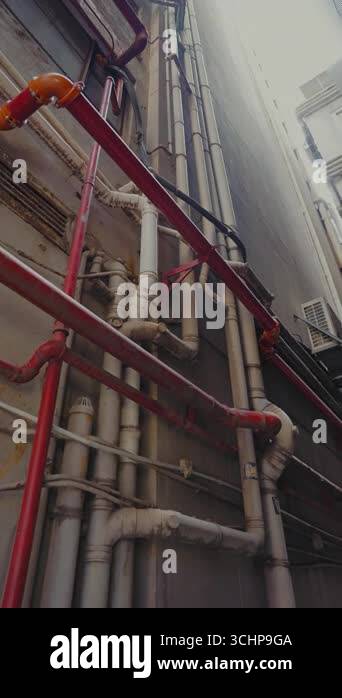 Detailed view of tangled industrial pipes and rusty tubes attached to ...