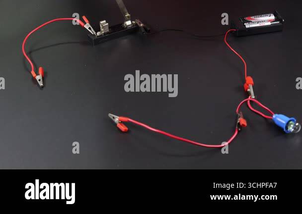 Hands connect wires to test electric circuit Stock Video Footage - Alamy