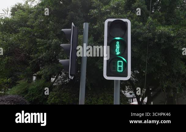 Slow motion of red pedestrian signal switching to green at crosswalk in ...