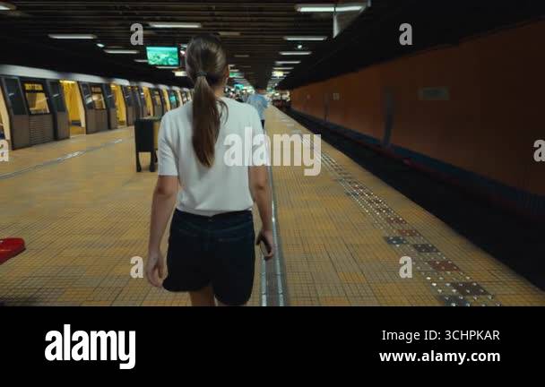 Female commuter strides through subway station, reflecting on her day ...