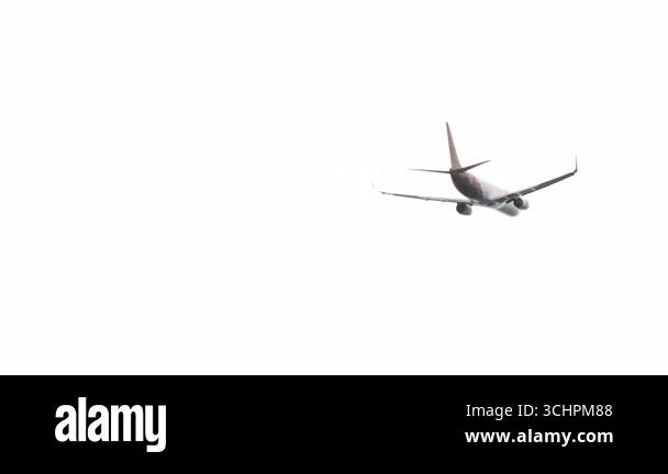 Long shot rear view jet passenger plane climbing in blue sky. Airliner ...