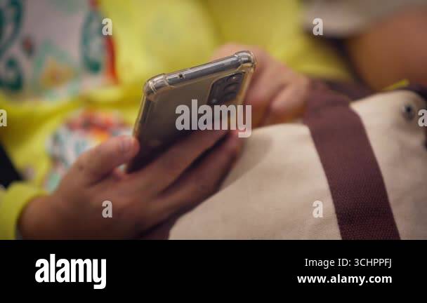 Slow motion close-up of hands texting on smartphone inside Taipei metro ...