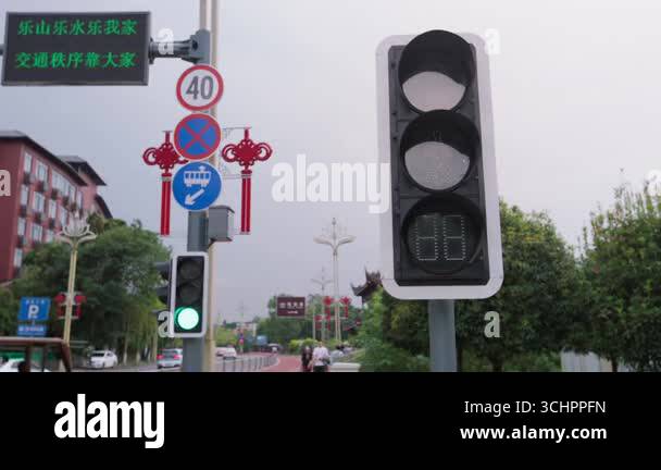 Traffic signal transitions from green to red in slow motion at urban ...