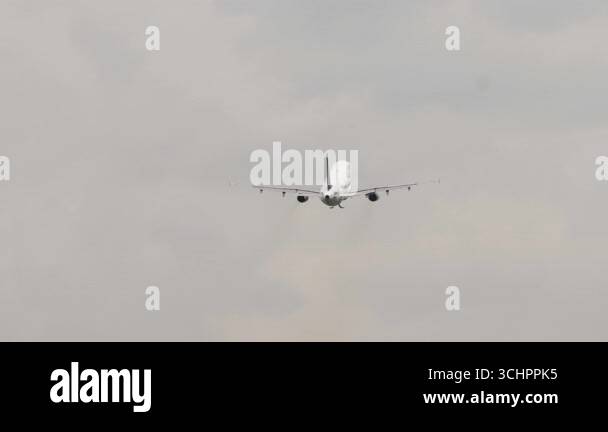 Rear view of a commercial airplane flying high in the clear blue sky ...