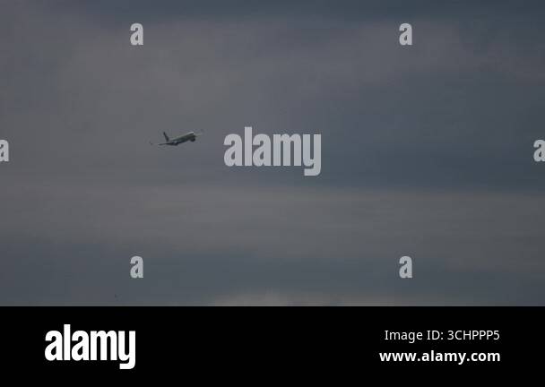 Long shot footage of a jet passenger plane climbing and turning in a ...