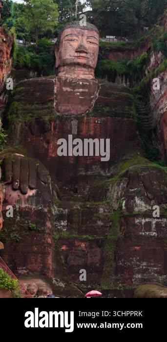 Vertical format slow motion of the Leshan Giant Buddha sculpture from ...